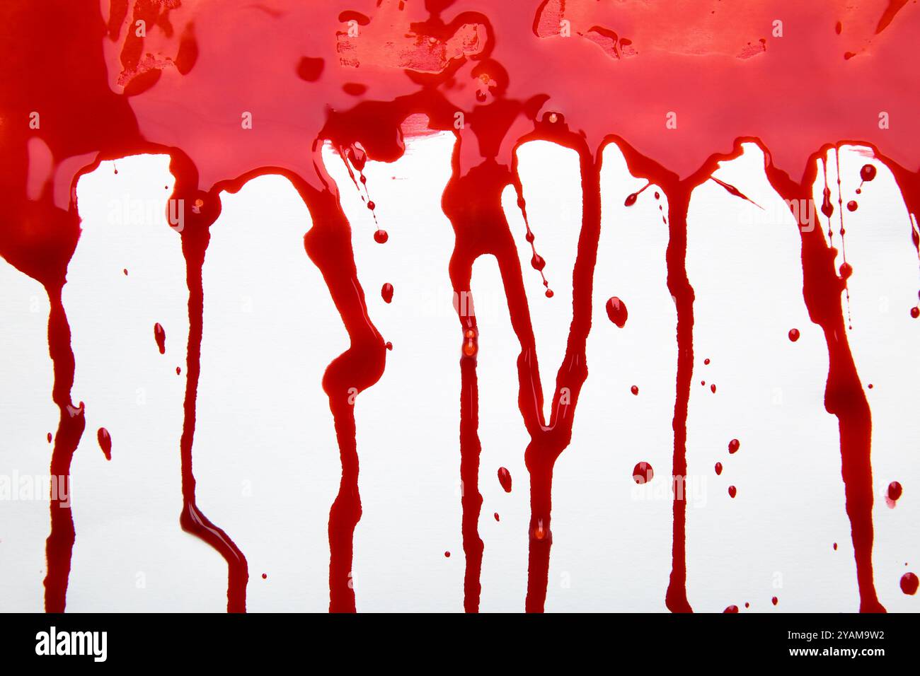 Leaking red blood stain on white background Stock Photo - Alamy