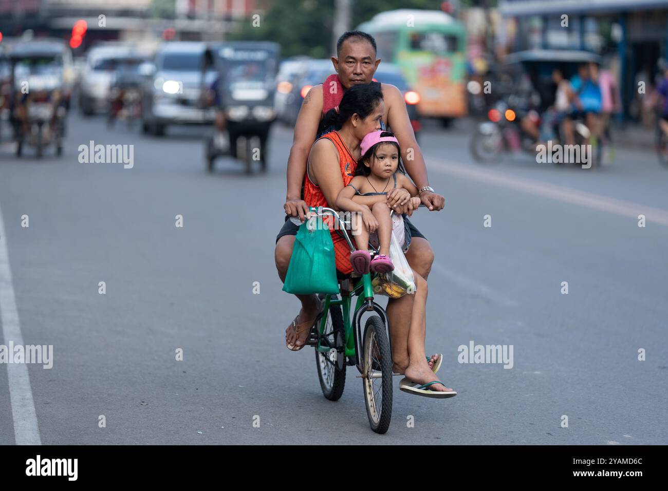 Typical daily life scene in the Philippines. A man pedals his small ...