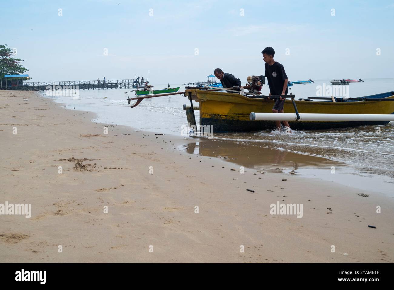 Fishermen are pushing their boats from the sea to the beach after ...