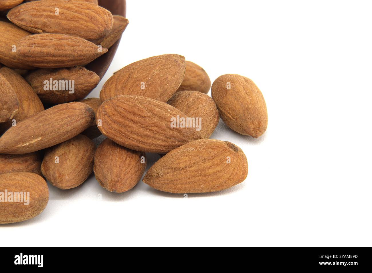 A detailed close-up of raw almonds showcasing their natural texture and ...