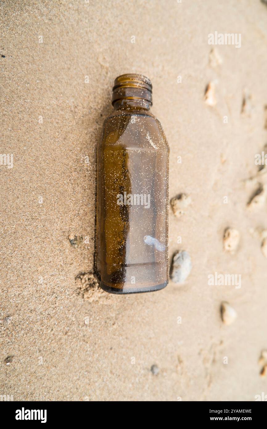 Empty glass bottles washed up on the beach Stock Photo - Alamy