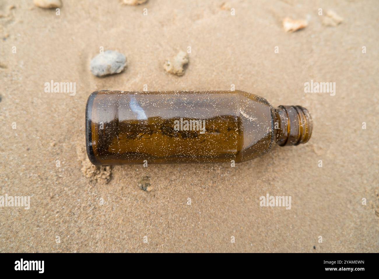 Empty glass bottles washed up on the beach Stock Photo - Alamy