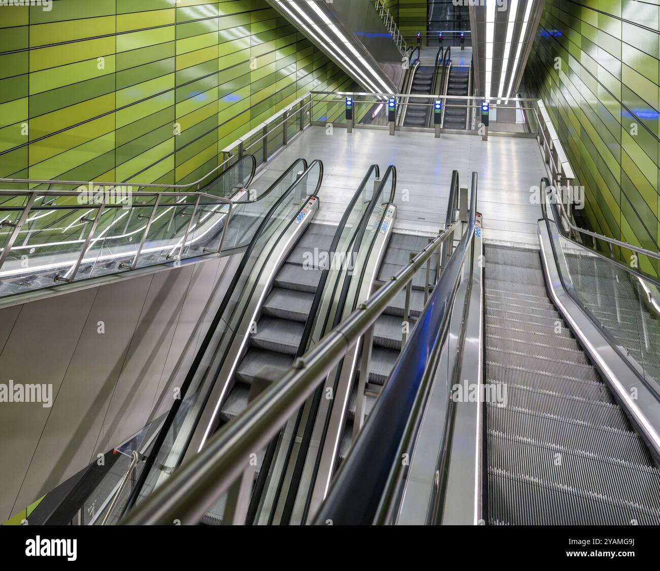Modern metro station with smooth green walls and escalators ...