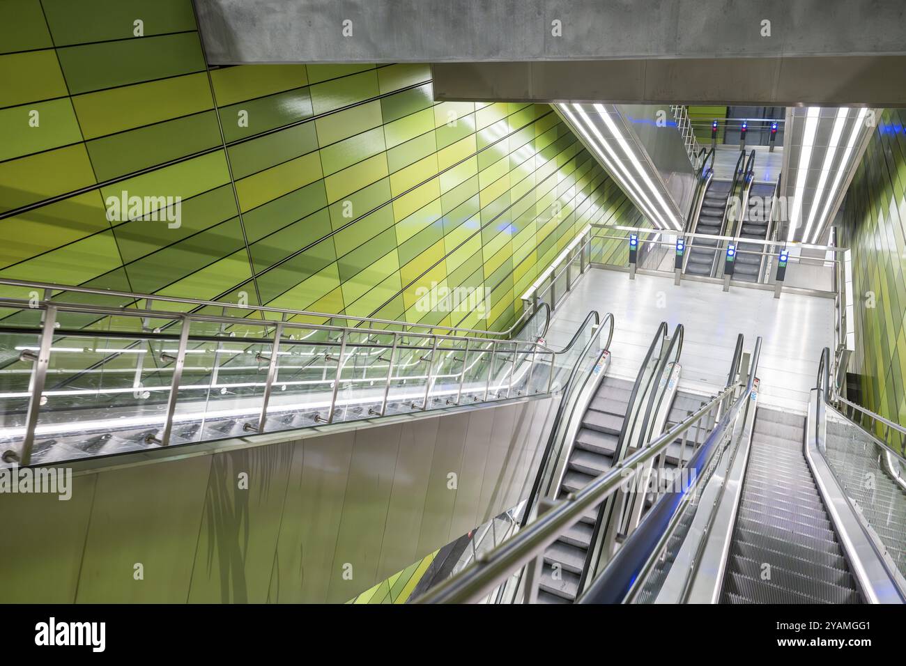 Modern metro station with smooth green walls and escalators ...