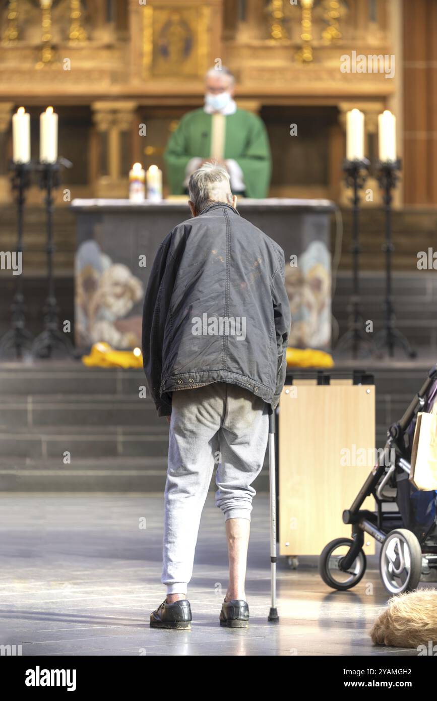 A mentally confused homeless man in the church, family mass with ...