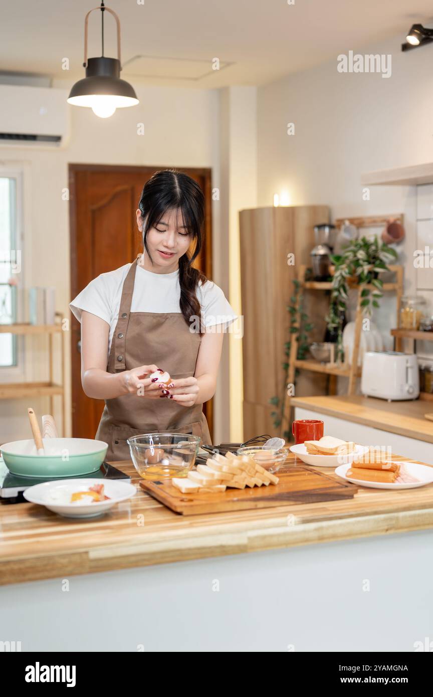Asian adult cracking an egg hi-res stock photography and images - Alamy