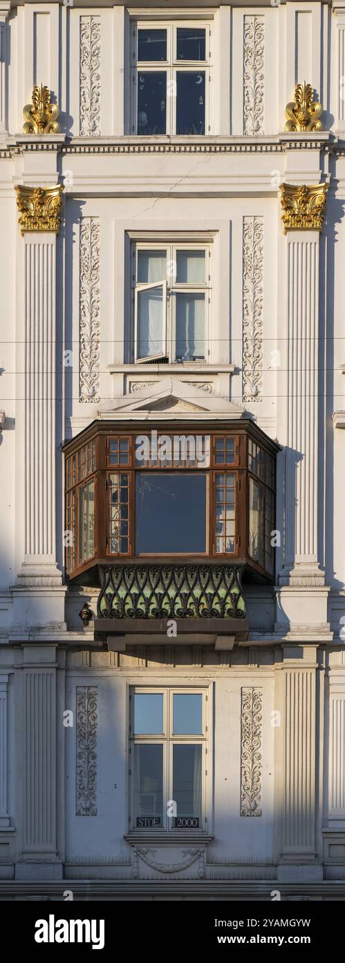 Neoclassical house facade with partially gilded stucco decorations and ...