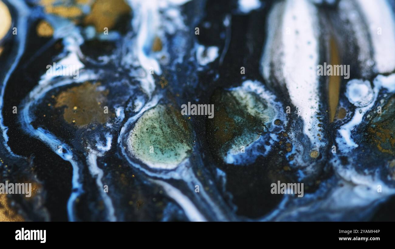 Dye emulsion. Magic paint spill. Defocused white blue black color ...