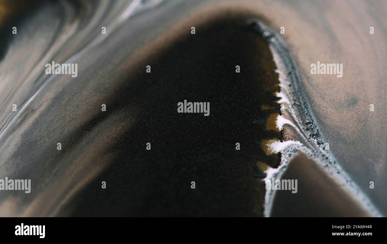 Liquid sand flow. Shimmer fluid drip. Defocused black gold white ...