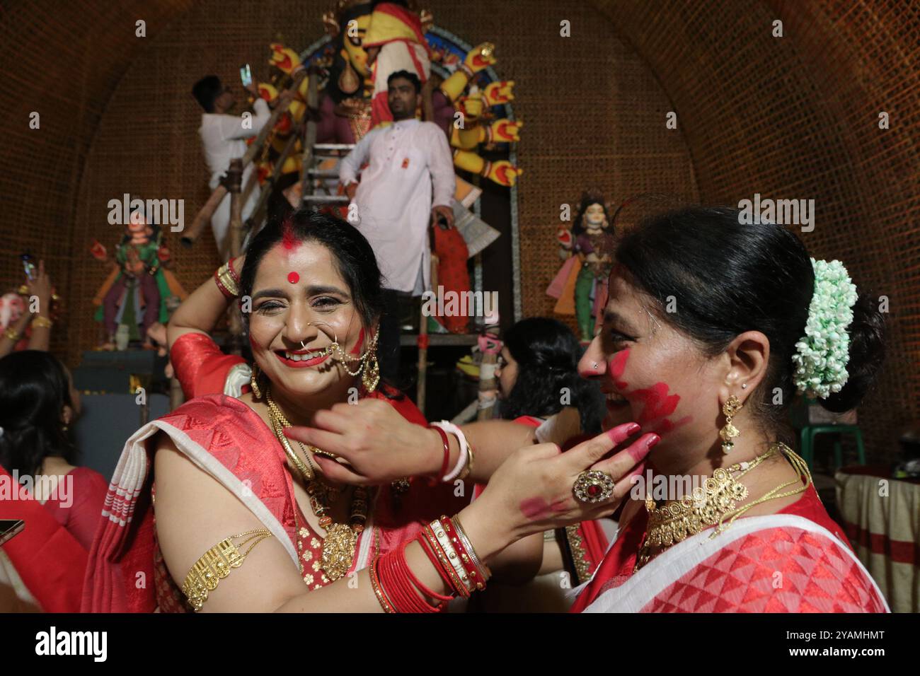 Non Exclusive: Women taking part in Sindoor Khela' or vermillion powder ...