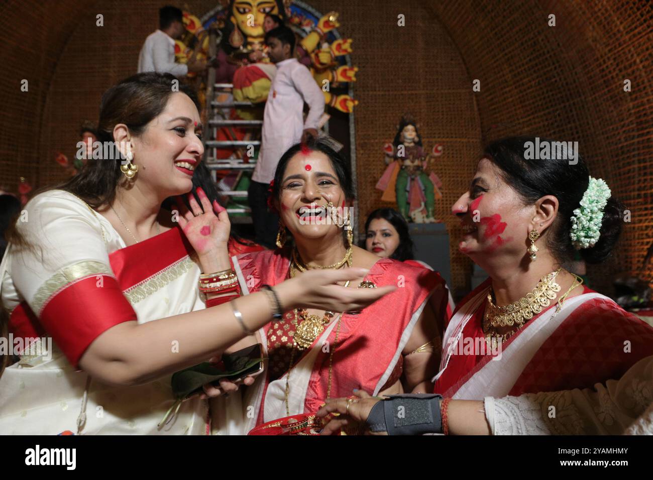 Non Exclusive: Women taking part in Sindoor Khela' or vermillion powder ...