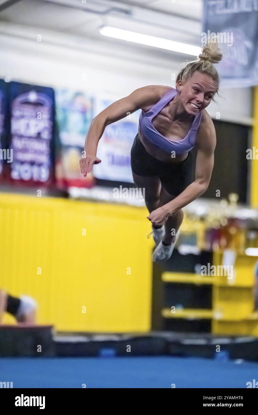 A toned gymnast perfects her routines at the gym ahead of a competition ...