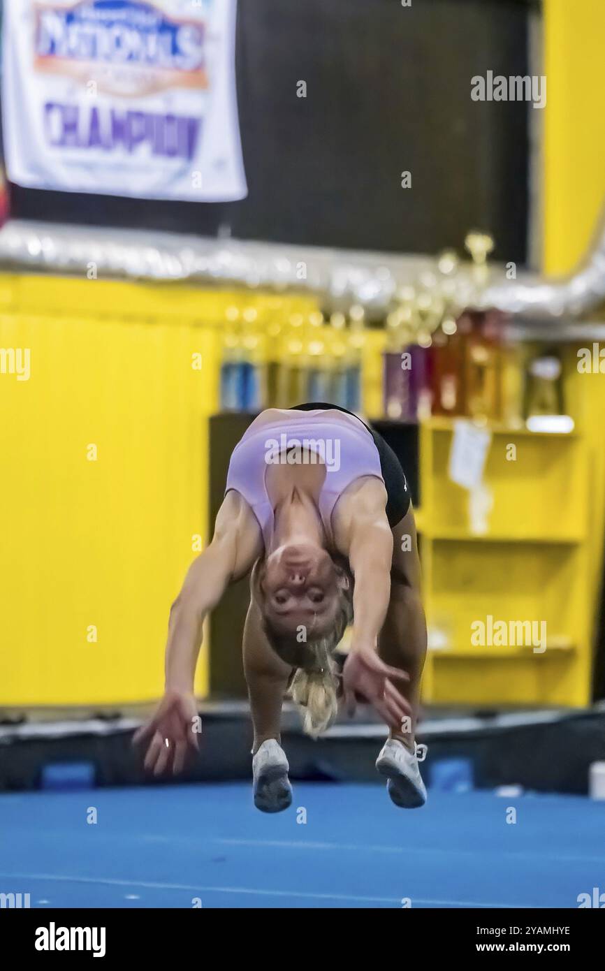 A toned gymnast perfects her routines at the gym ahead of a competition ...