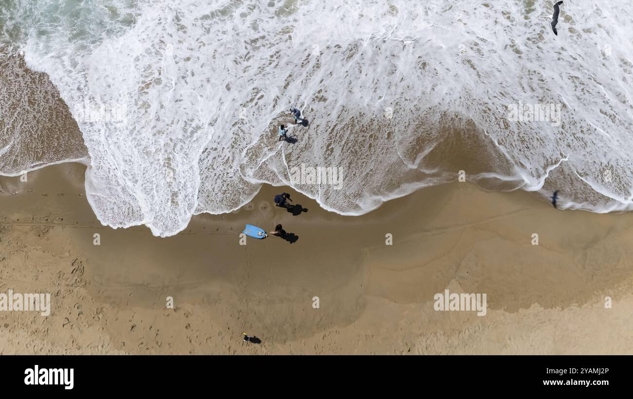 Swimmers glide through crystal-blue waves off California's coast, under ...
