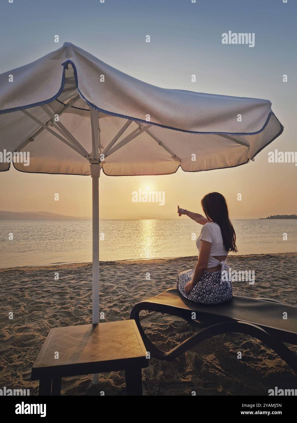 Young woman sitting on a sunbed at Sunny Beach resort in Bulgaria ...