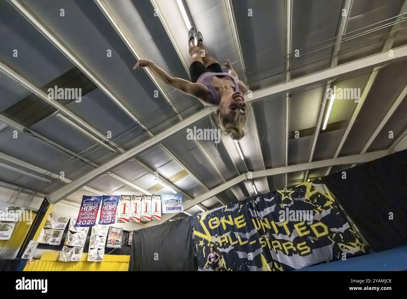 A toned gymnast perfects her routines at the gym ahead of a competition ...
