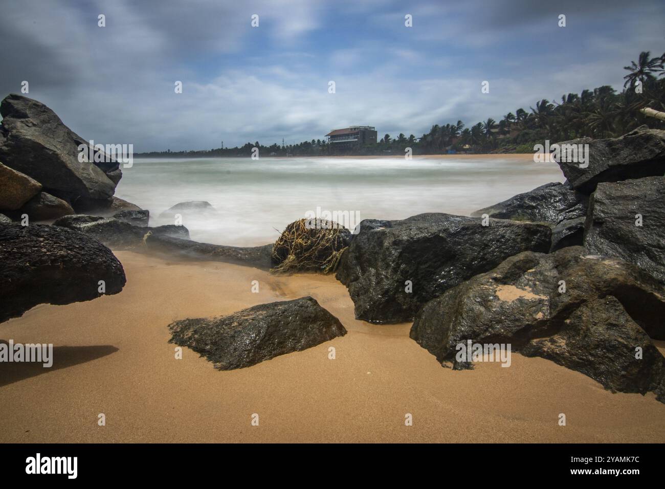 Beach, with lava rocks and vegetation, view of the sea in the evening ...
