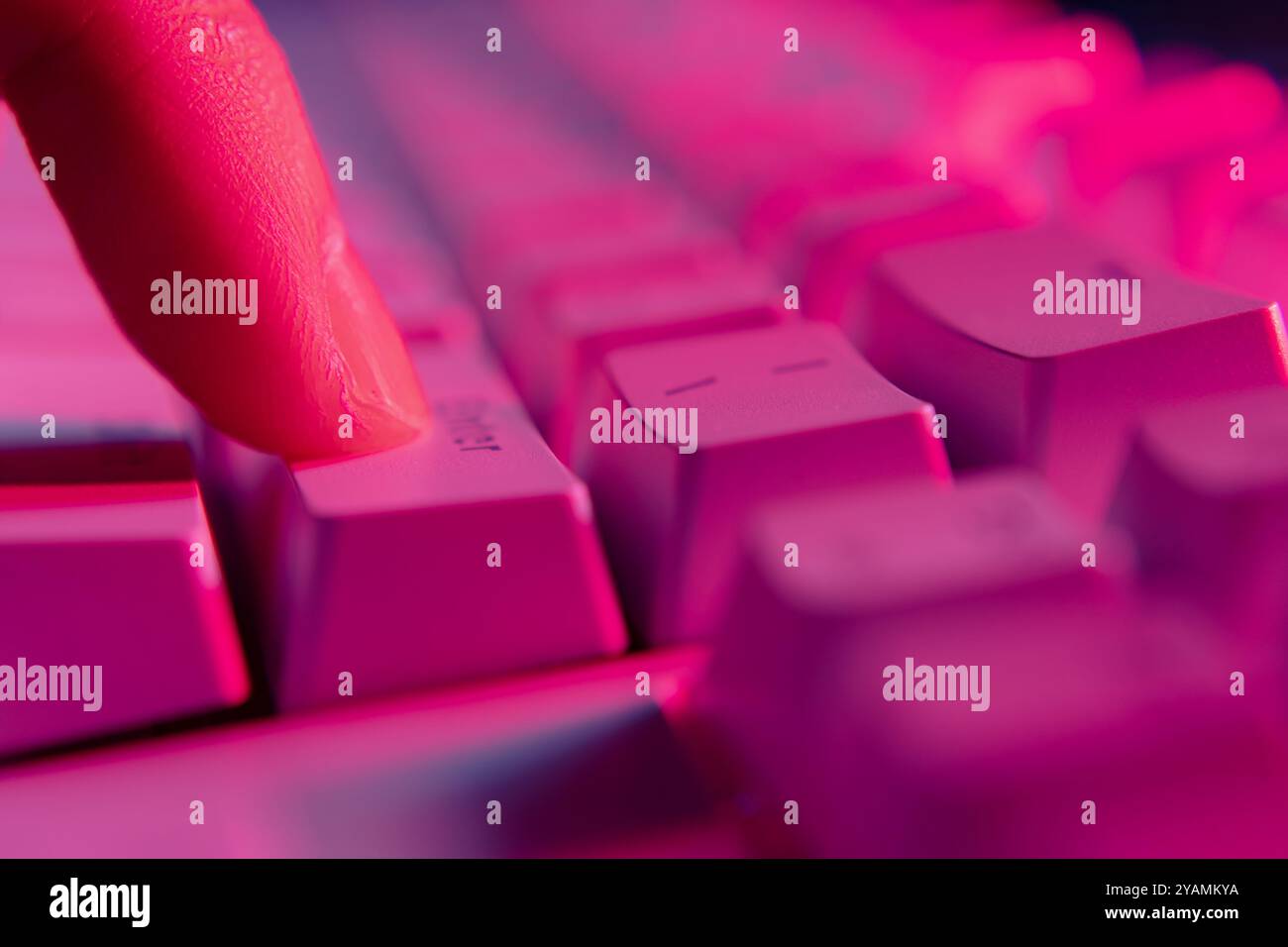 Press enter button on a keyboard in pink light Stock Photo - Alamy
