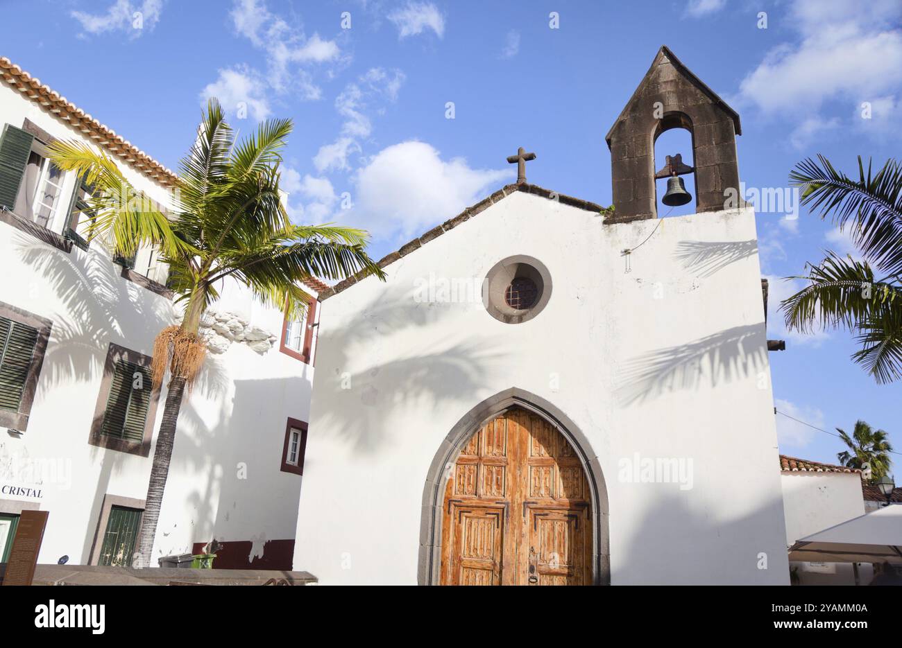 Cute white chapel with a gothic style door Stock Photo - Alamy