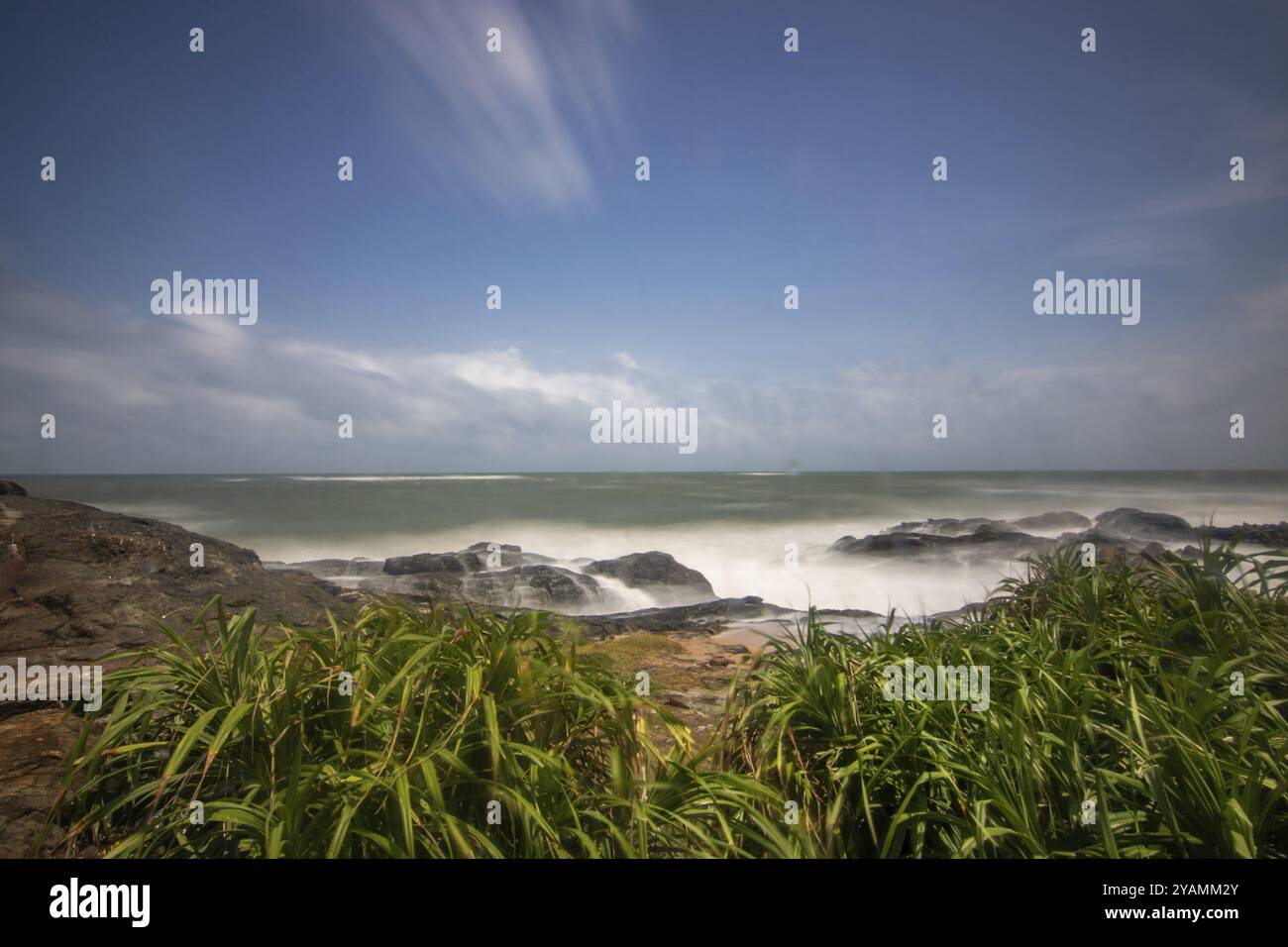 Beach, with lava rocks and vegetation, view of the sea in the evening ...