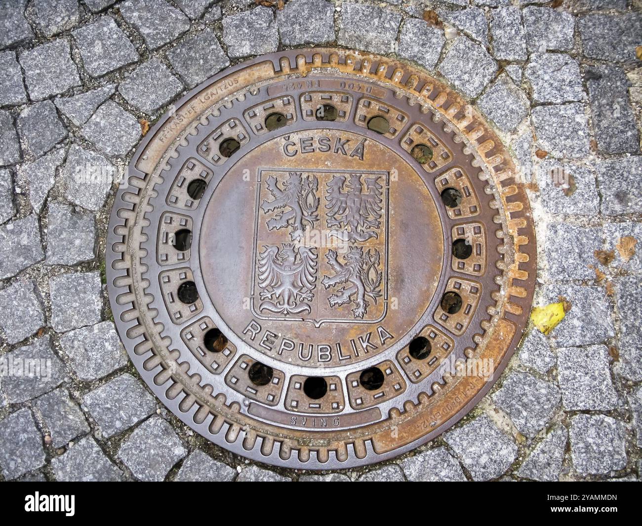 Hatch of sewage on the paving road in Tabor, Czech Republic, Europe ...