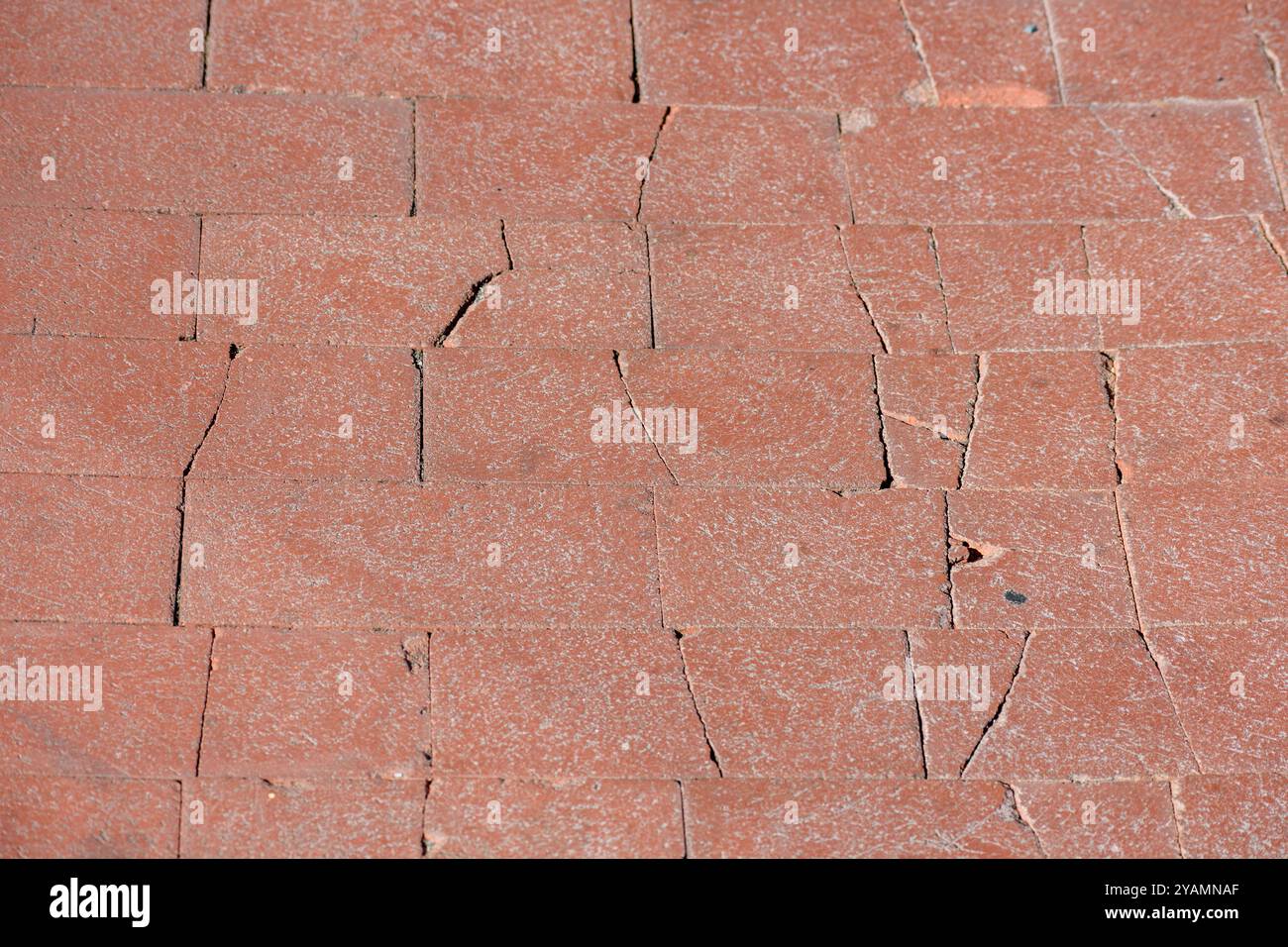 Cracked red paving bricks, showing visible signs of wear and age Stock ...