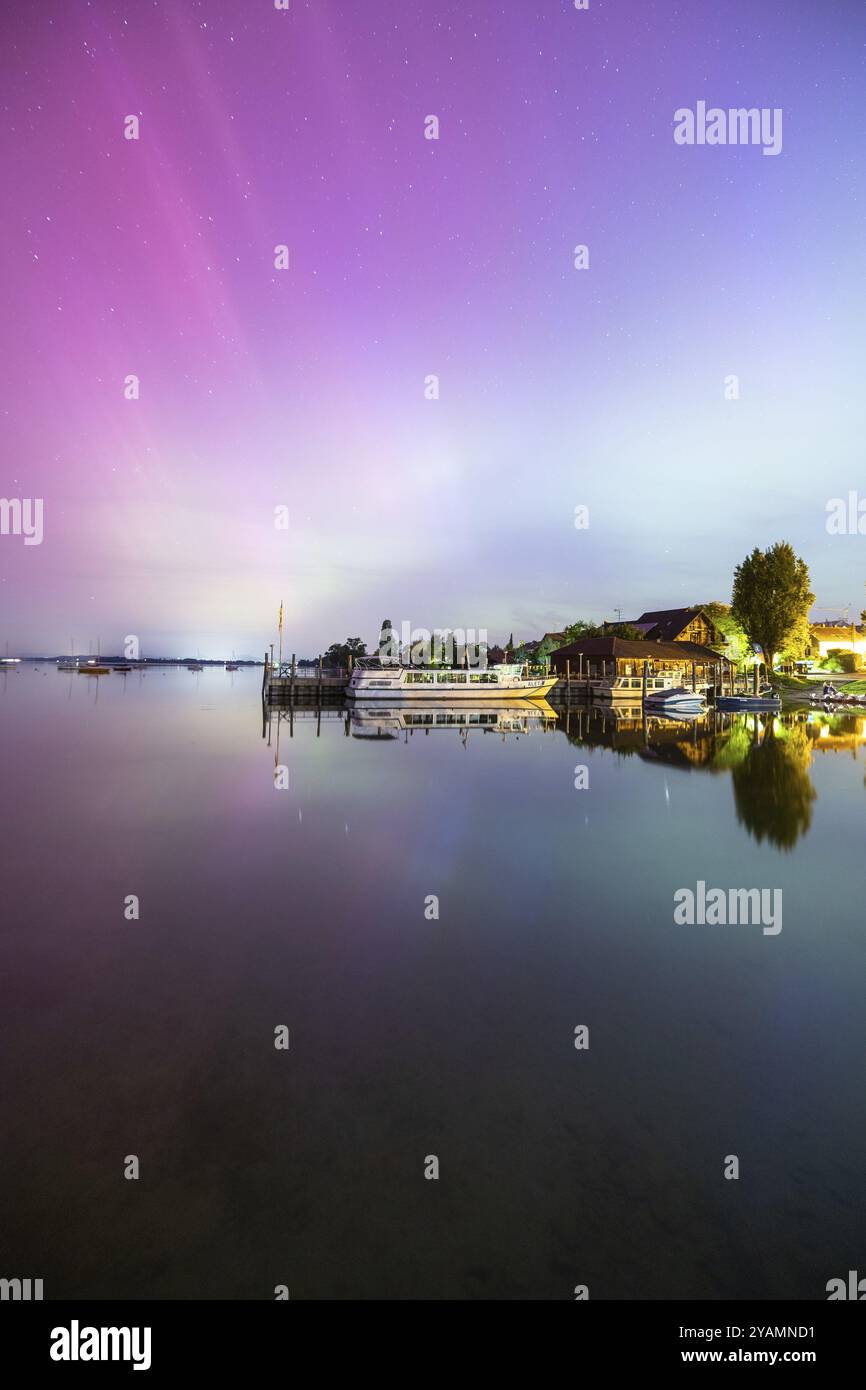 Calm lake at night with clear reflection of the surrounding nature and ...