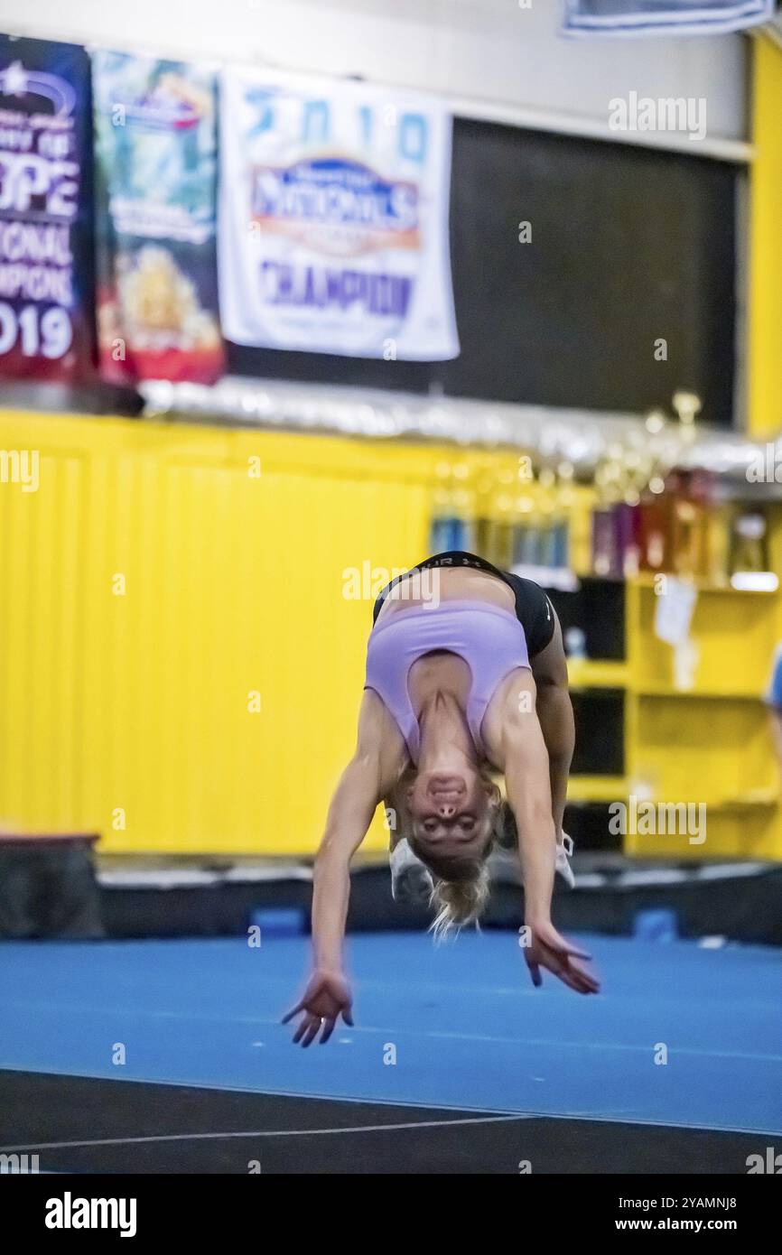 A toned gymnast perfects her routines at the gym ahead of a competition ...