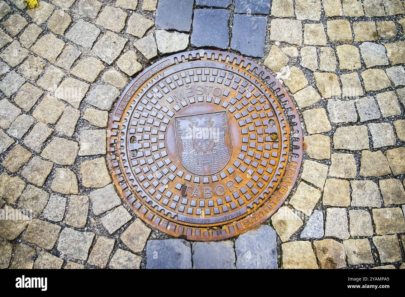 Hatch of sewage on the paving road in Tabor, Czech Republic, Europe ...