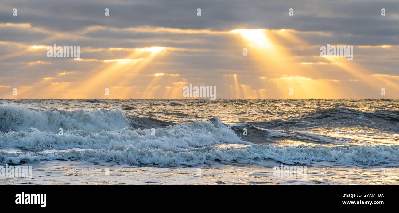 Sun rays illuminate the Atlantic coastline shortly after sunrise in ...