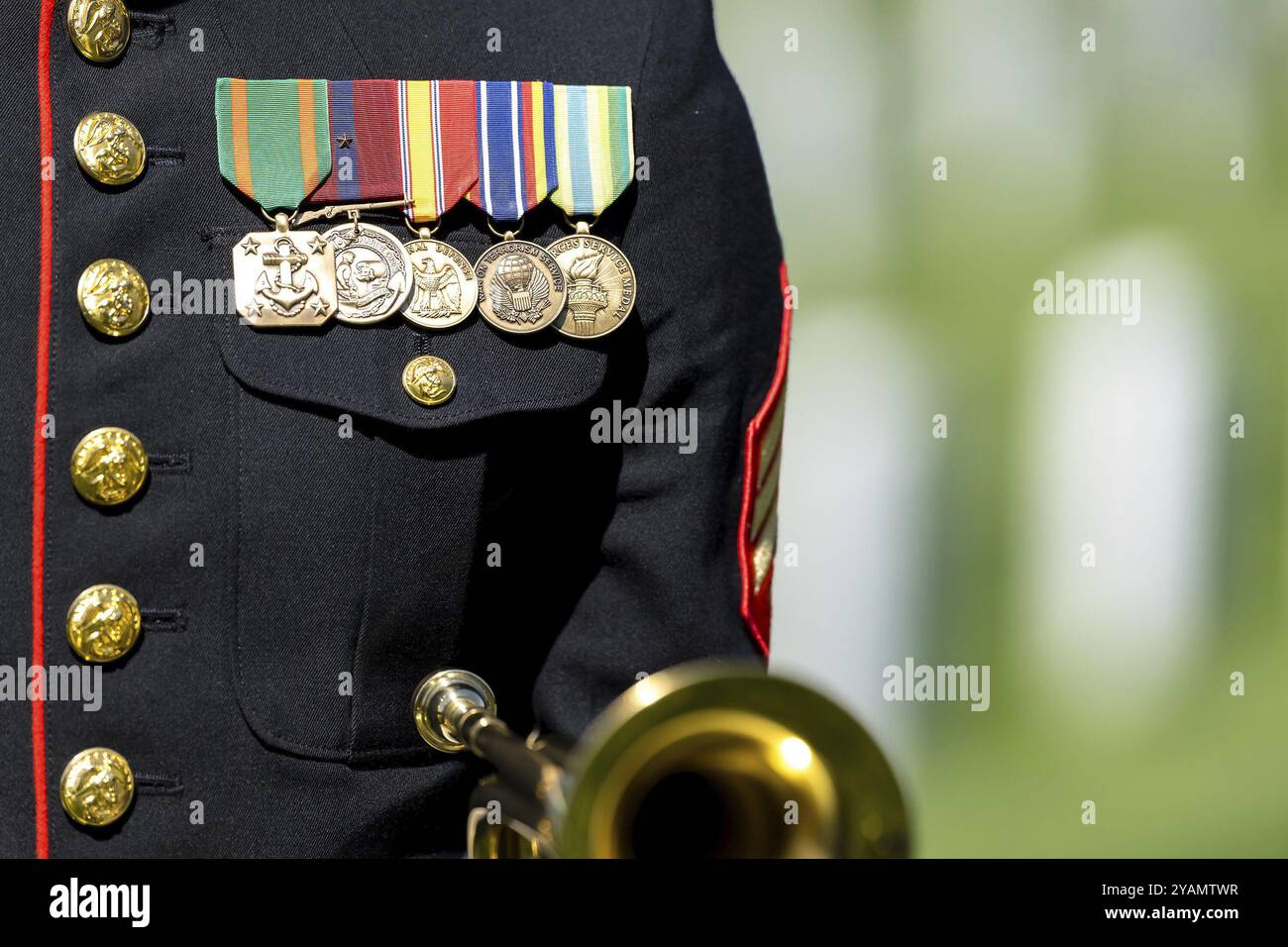 A poignant moment unfolds as a Marine plays taps, honoring a fallen ...