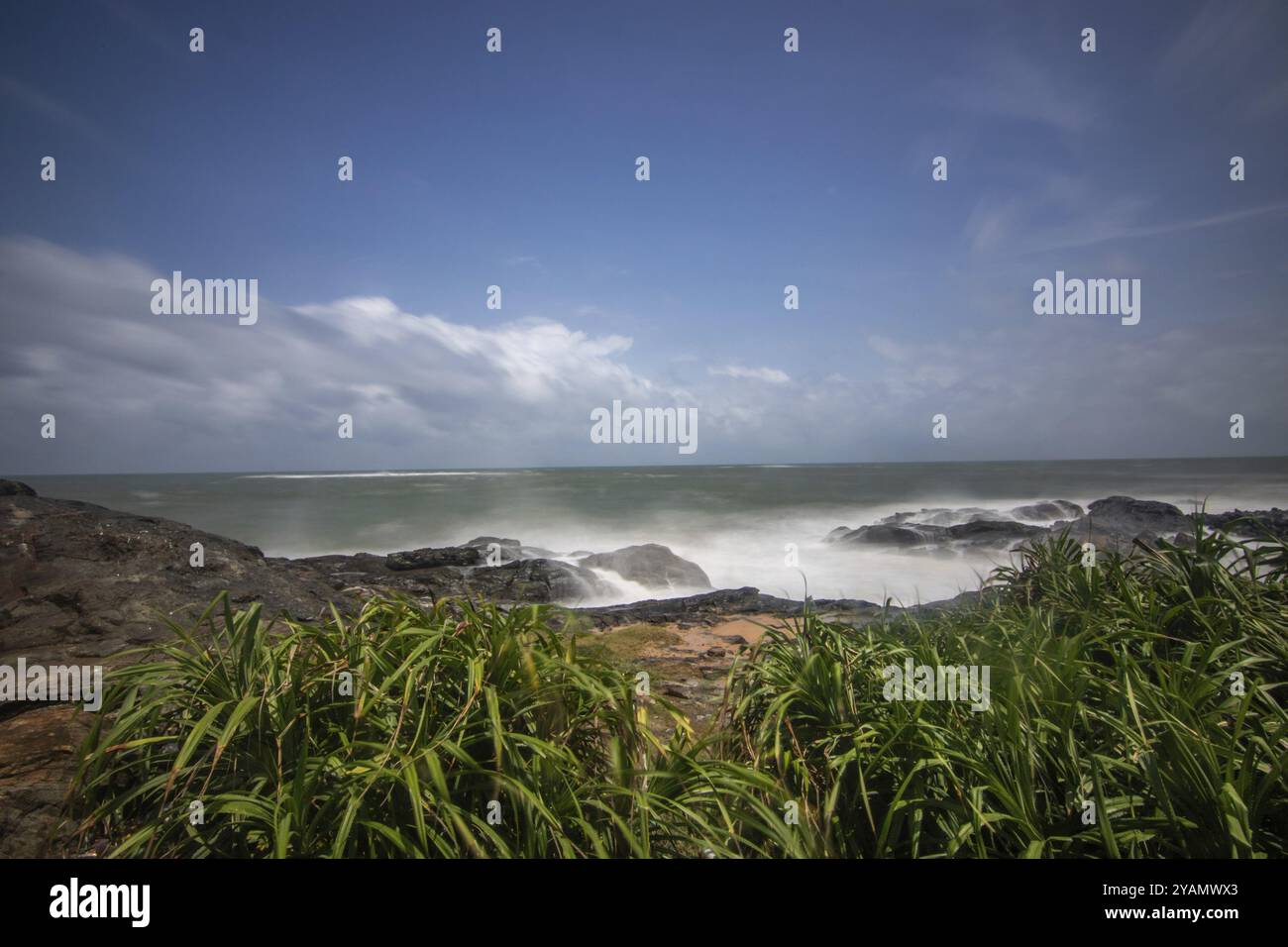 Beach, with lava rocks and vegetation, view of the sea in the evening ...