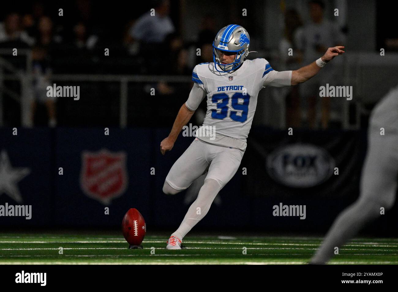 Detroit Lions place kicker Jake Bates (39) kicks the ball on a kickoff ...