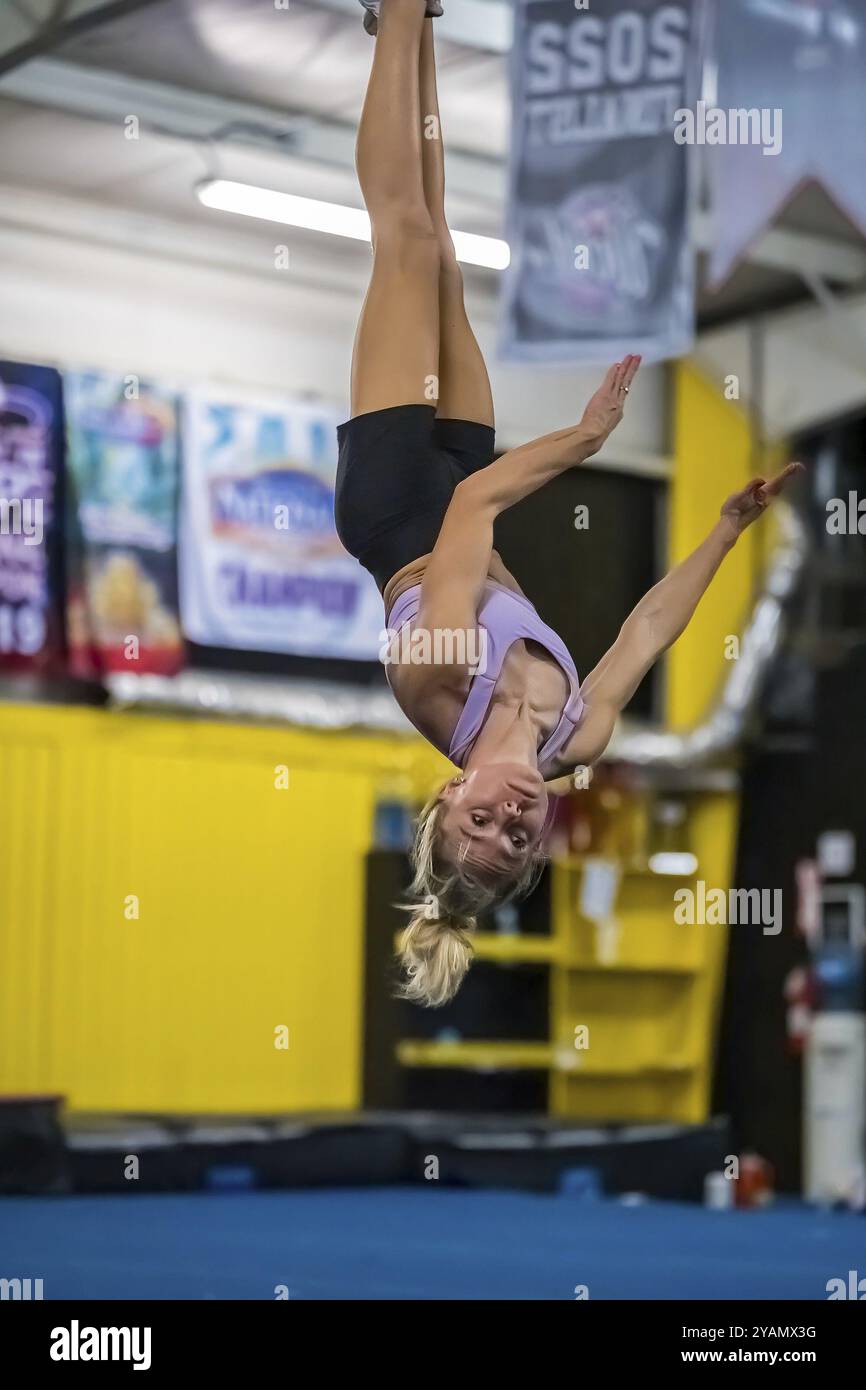 A toned gymnast perfects her routines at the gym ahead of a competition ...