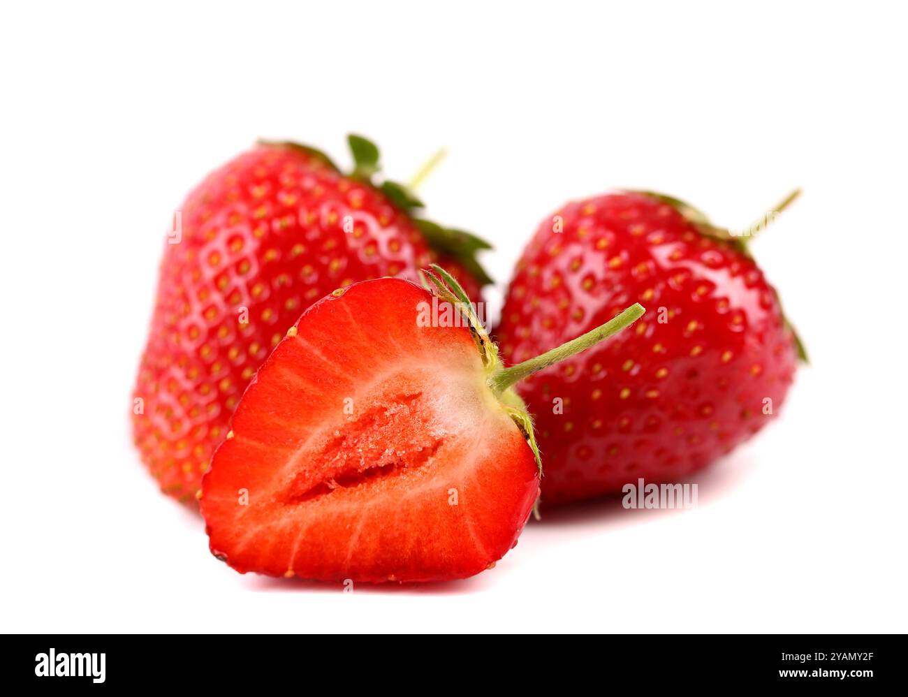 strawberries two and half isolated on white Stock Photo - Alamy