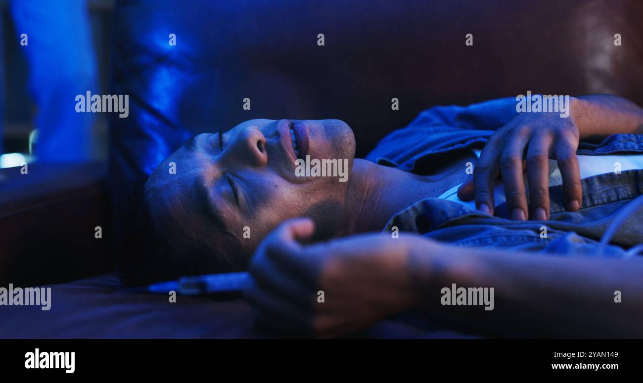 Drugs, overdose and man on sofa with syringe, health risk and narcotic ...