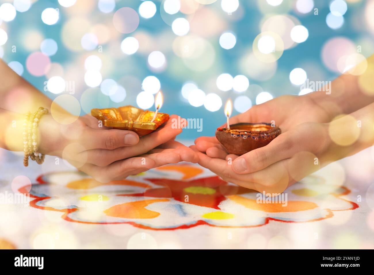 Hands of Indian women holding diya lamps for Diwali (Festival of lights ...