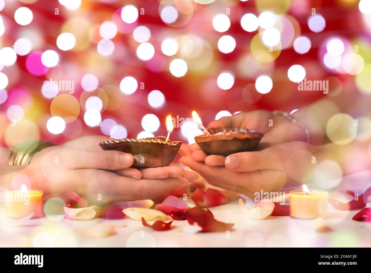 Hands of Indian women holding diya lamps for Diwali (Festival of lights ...