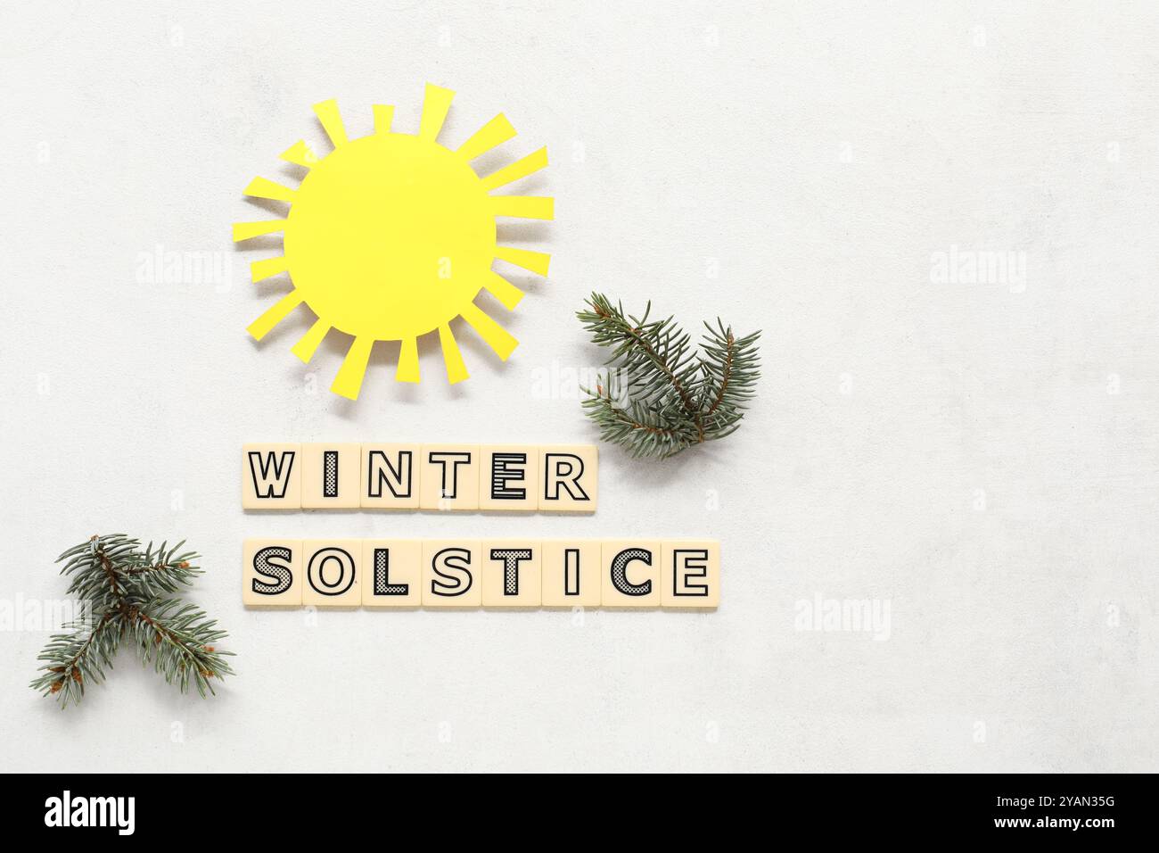 Text WINTER SOLSTICE with paper sun and fir branches on white ...