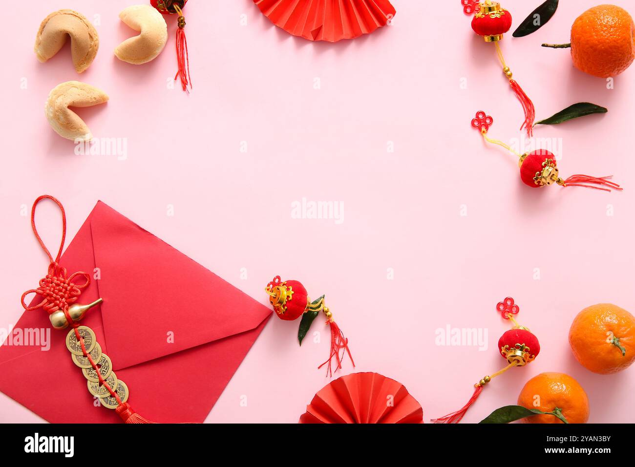 Frame made from red envelope, tangerines and Chinese symbols on pink ...