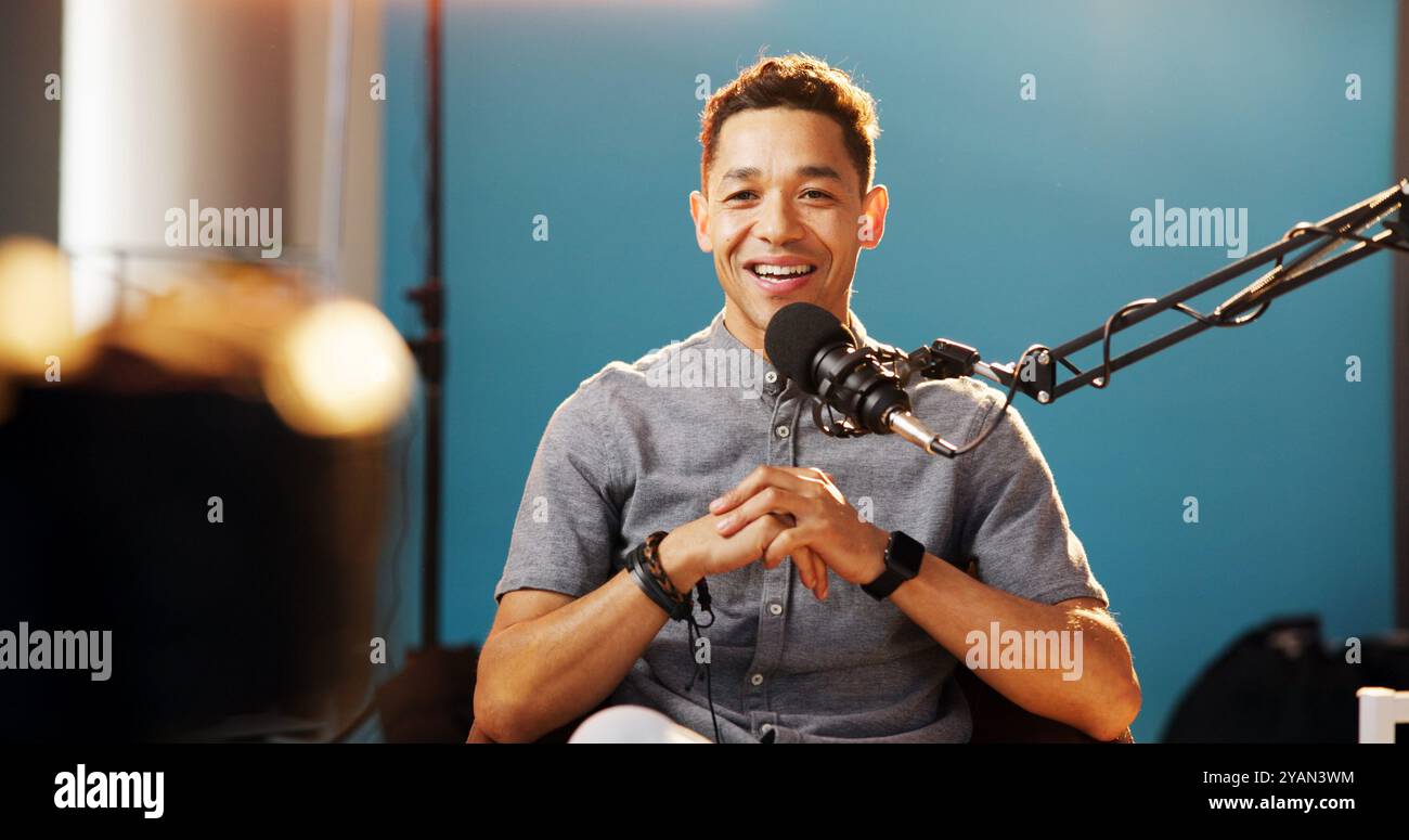 Live streaming, man and smile as radio presenter with microphone, talk ...