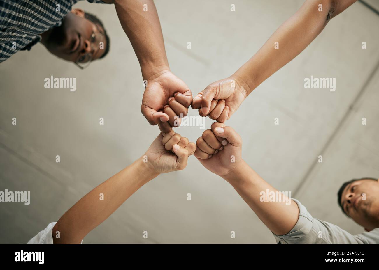Business, people and hands together for fist bump in office with below, unity and team building ...