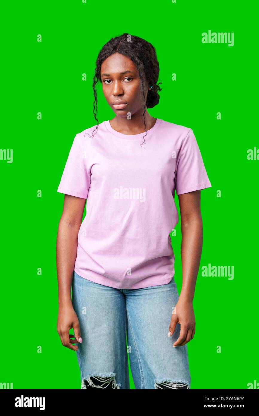 Young woman with an expression of contemplation poses against a bright ...