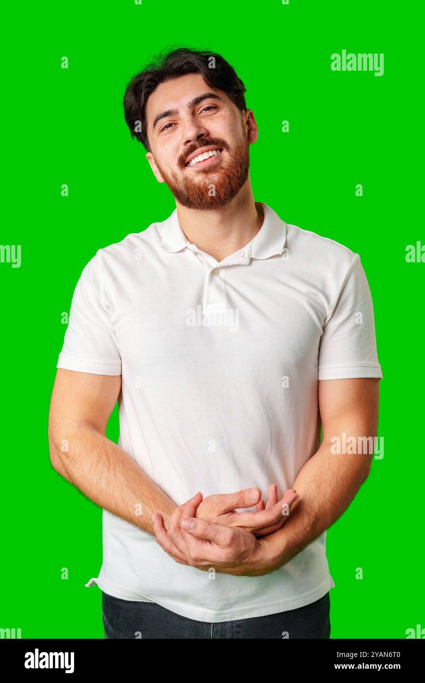 A man with a beard smiles confidently against a bright green background ...
