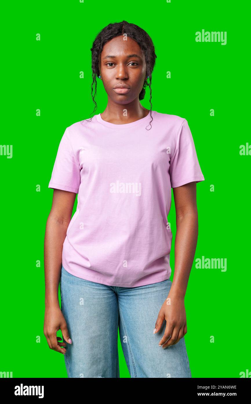 Young woman with an expression of contemplation poses against a bright ...