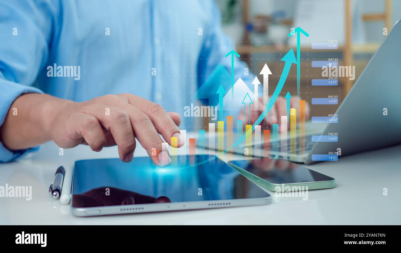 Businessman use tablet showing a growing virtual hologram of analytics ...