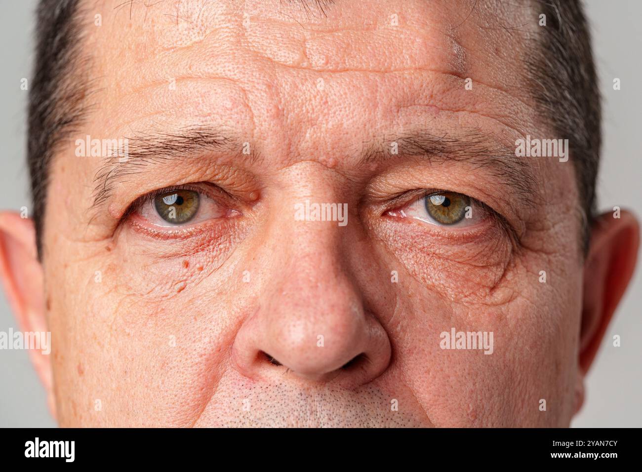 Vew of an older man's face highlighting expressive eyes and textured ...