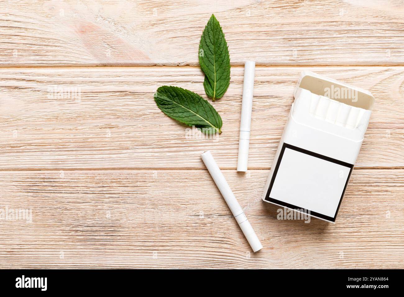 Pack of menthol cigarettes and fresh mint on colored table, Menthol ...