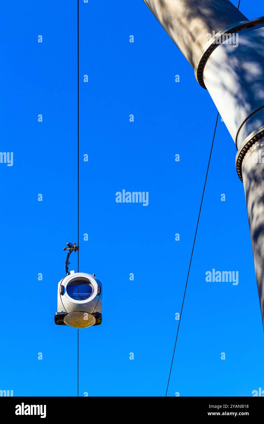 a cable car with round passenger cabins. cable car against blue sky ...
