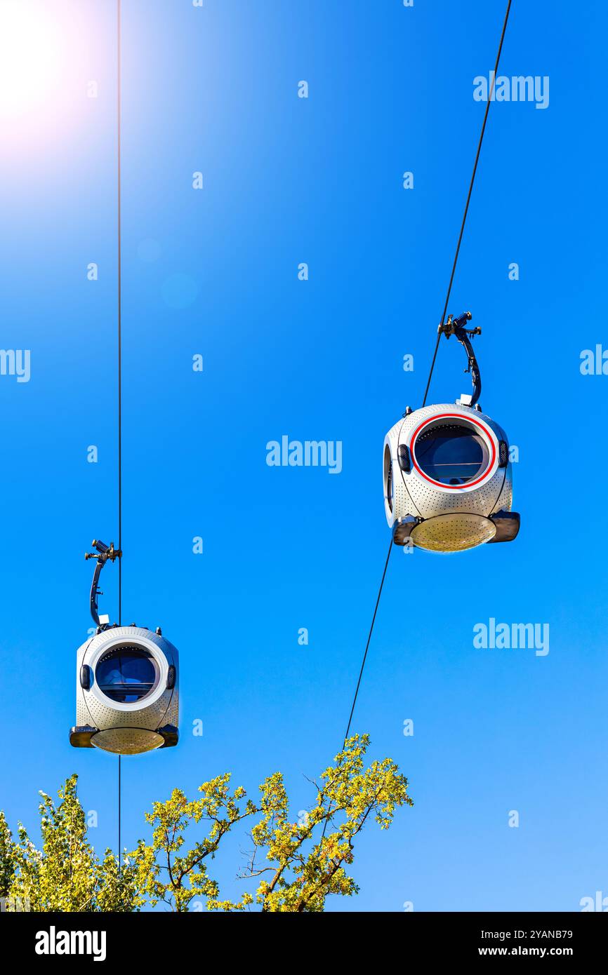 a cable car with round passenger cabins. cable car against blue sky ...